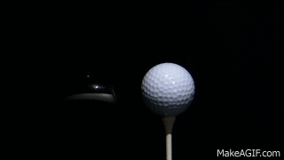 Close up of a golf ball being hit on a black background. on Make a GIF
