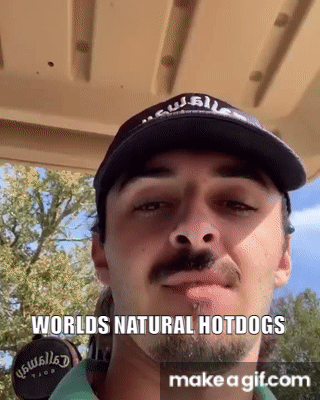 Guy takes a bite out of a cattail plant saying it’s a hotdog. on Make a GIF