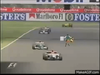Guy runs onto race track during Formula F1 race! on Make a GIF
