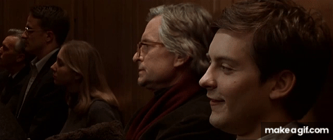 Tobey Maguire laughing loudly in an auditorium on Make a GIF